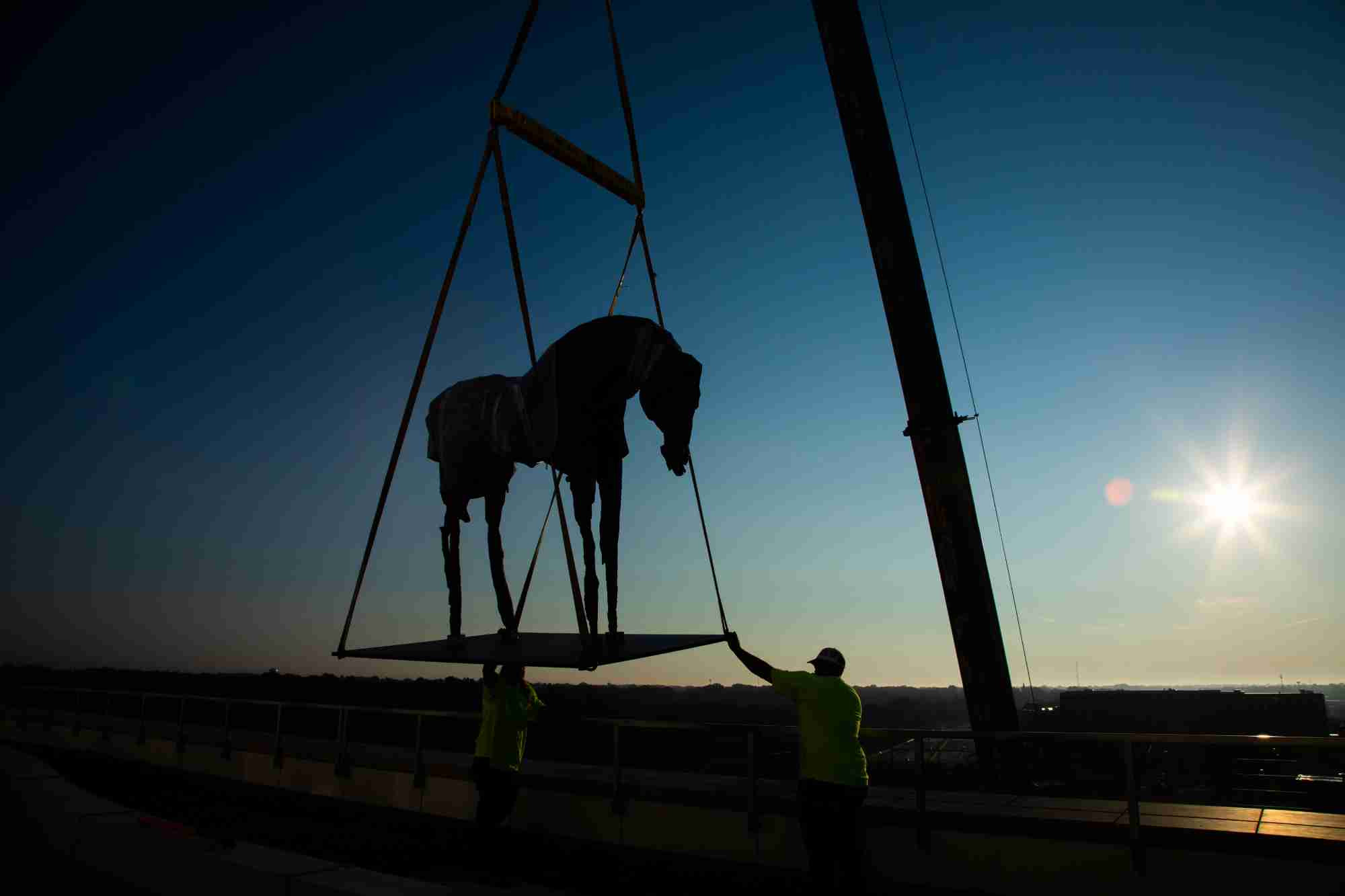 Crane places sculpture from renowned artist atop Health Campus building ...